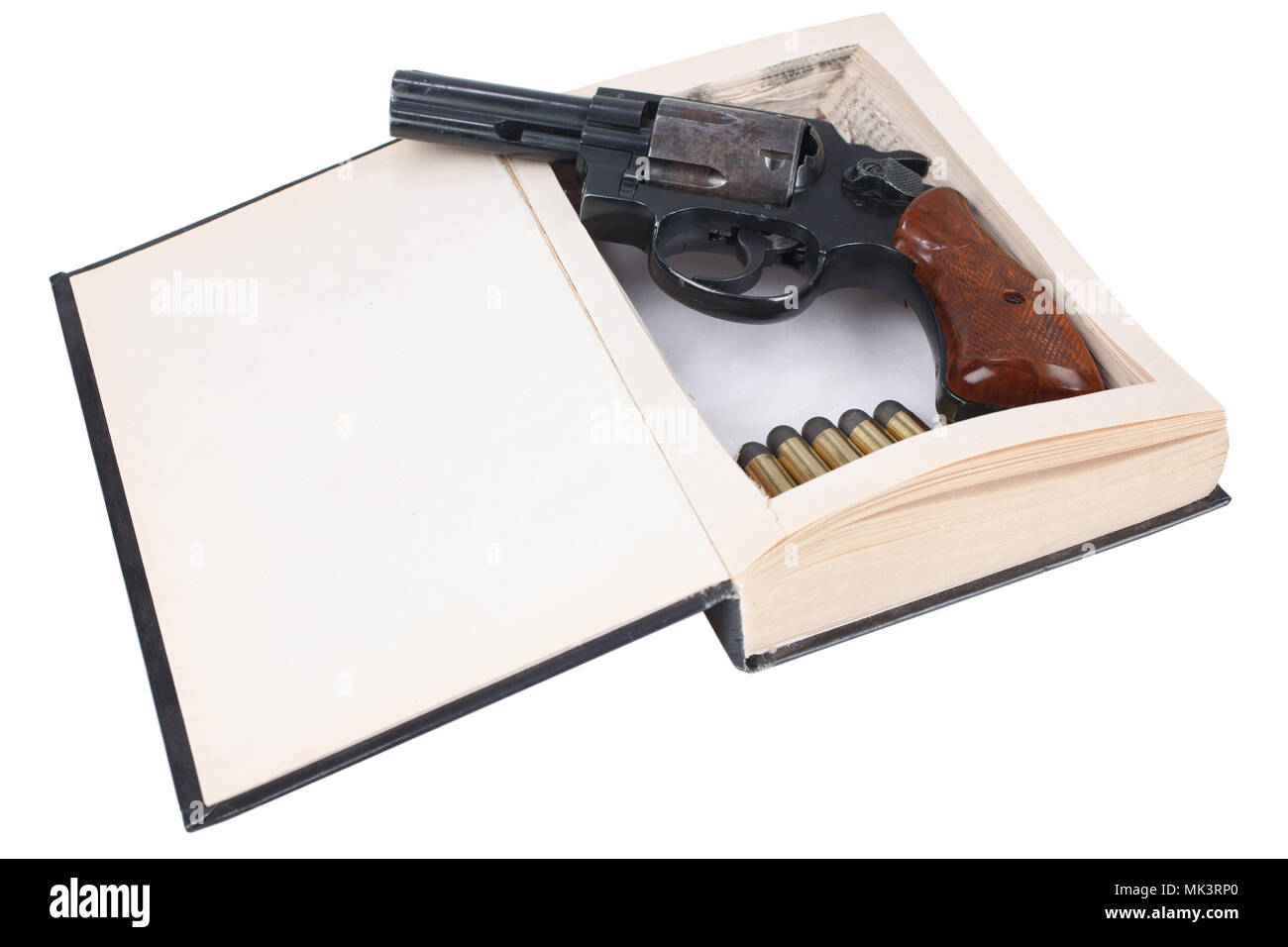 Revolver gun with cartridges hidden in a book isolated on white ...