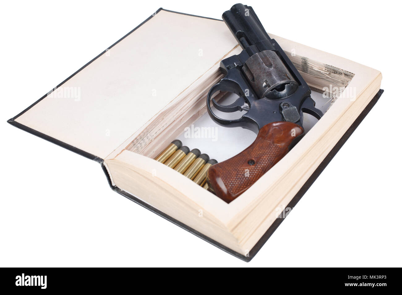 Revolver gun with cartridges hidden in a book isolated on white ...