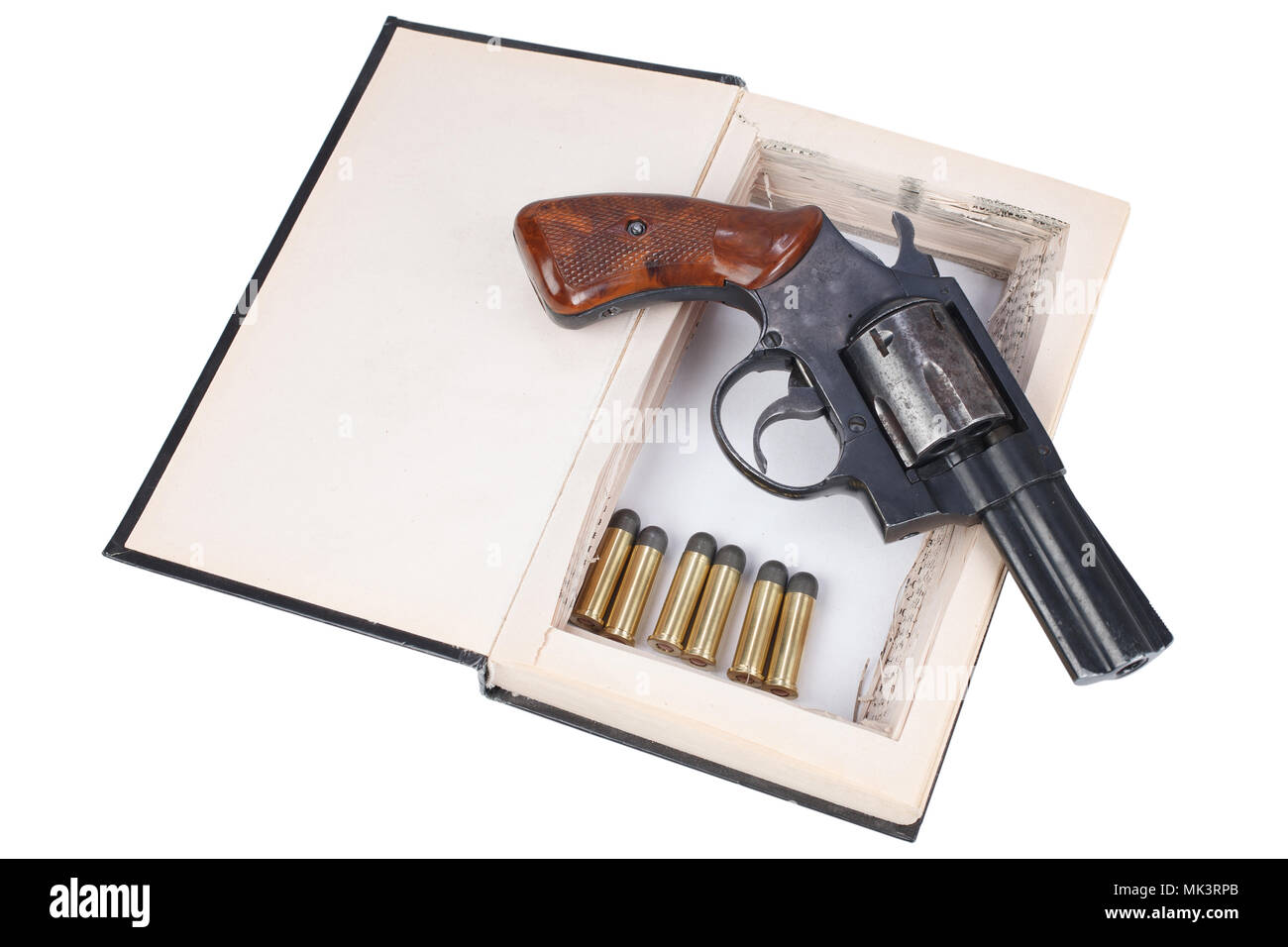 Revolver gun with cartridges hidden in a book isolated on white ...