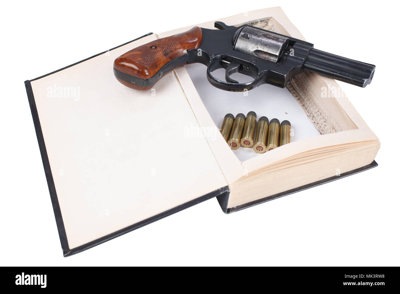 Revolver gun with cartridges hidden in a book isolated on white ...