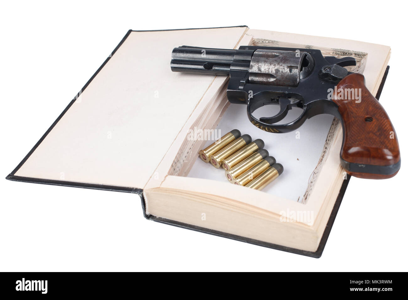 Revolver gun with cartridges hidden in a book isolated on white ...