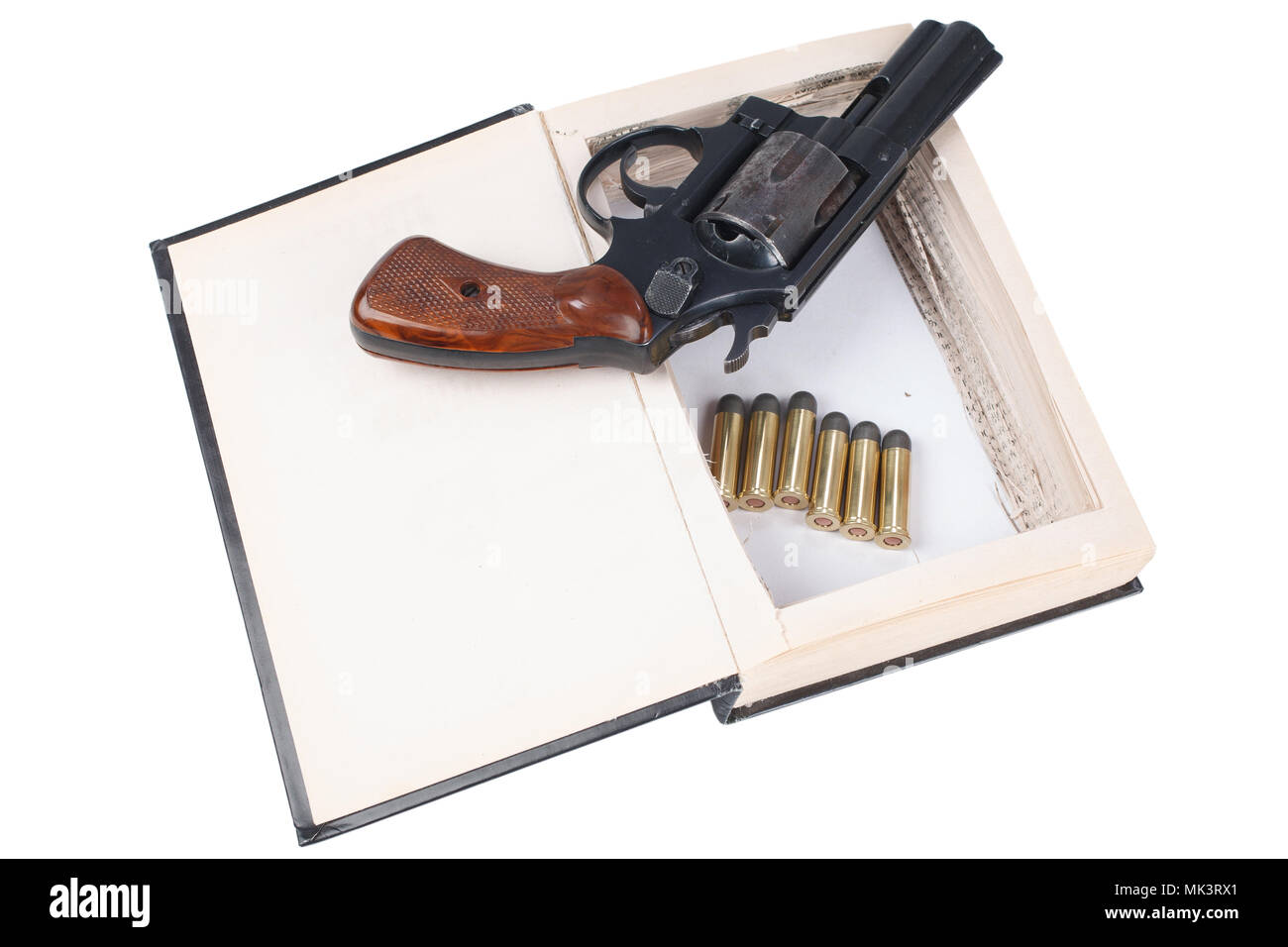 Revolver gun with cartridges hidden in a book isolated on white ...