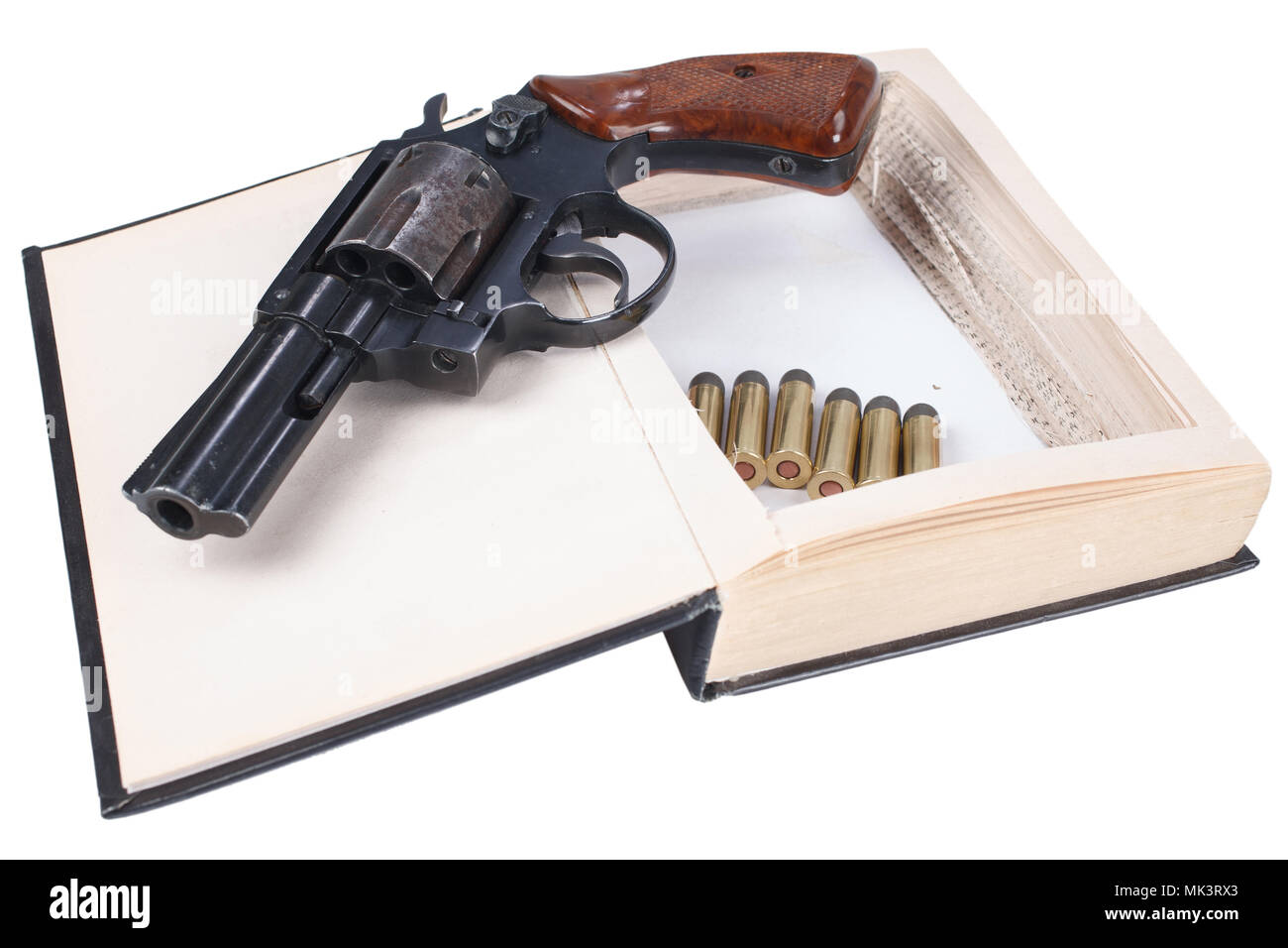 Revolver gun with cartridges hidden in a book isolated on white ...