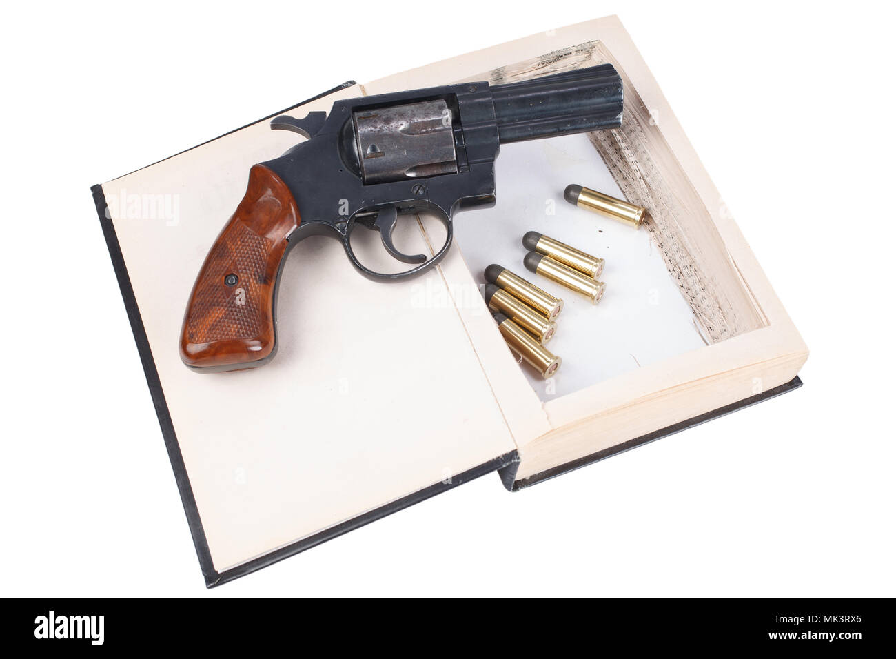 Revolver gun with cartridges hidden in a book isolated on white ...