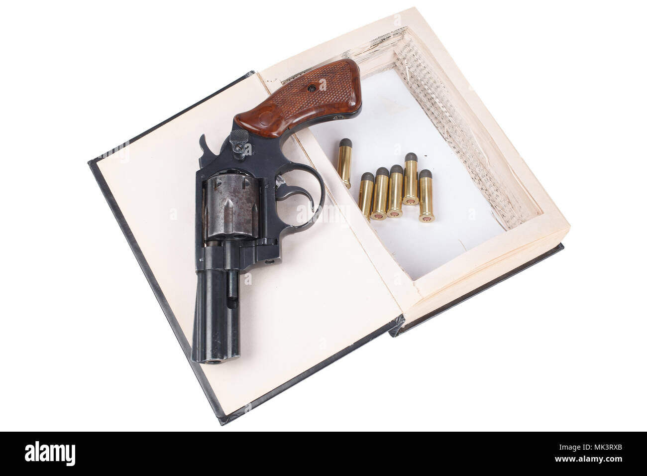 Revolver gun with cartridges hidden in a book isolated on white ...