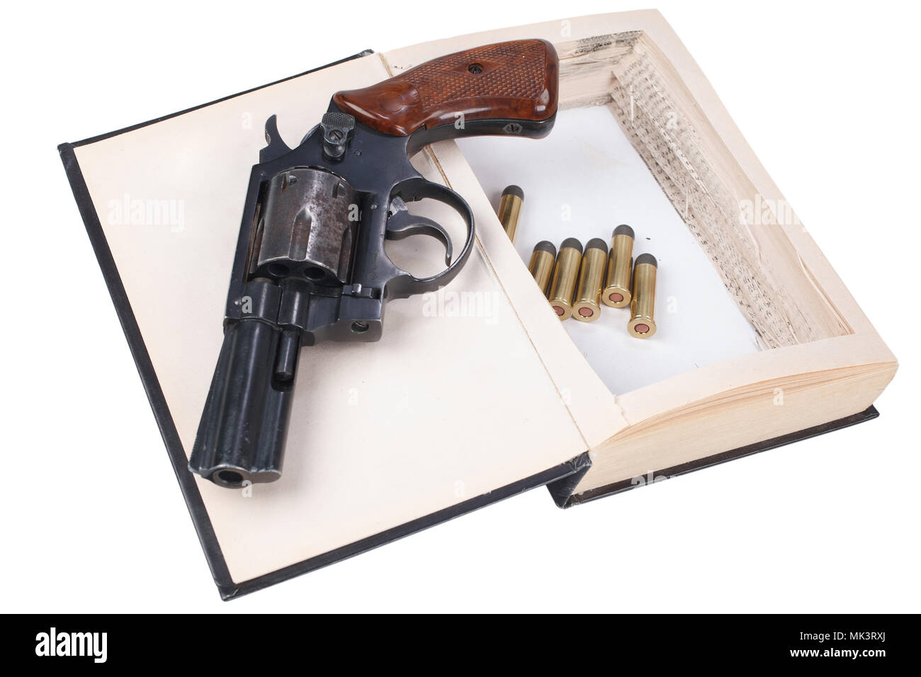 Revolver gun with cartridges hidden in a book isolated on white ...
