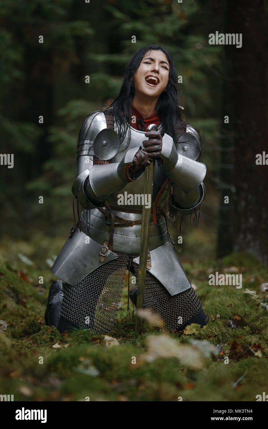 A Beautiful Warrior Girl With A Sword Wearing Chainmail And Armor In A Mysterious Forest Stock