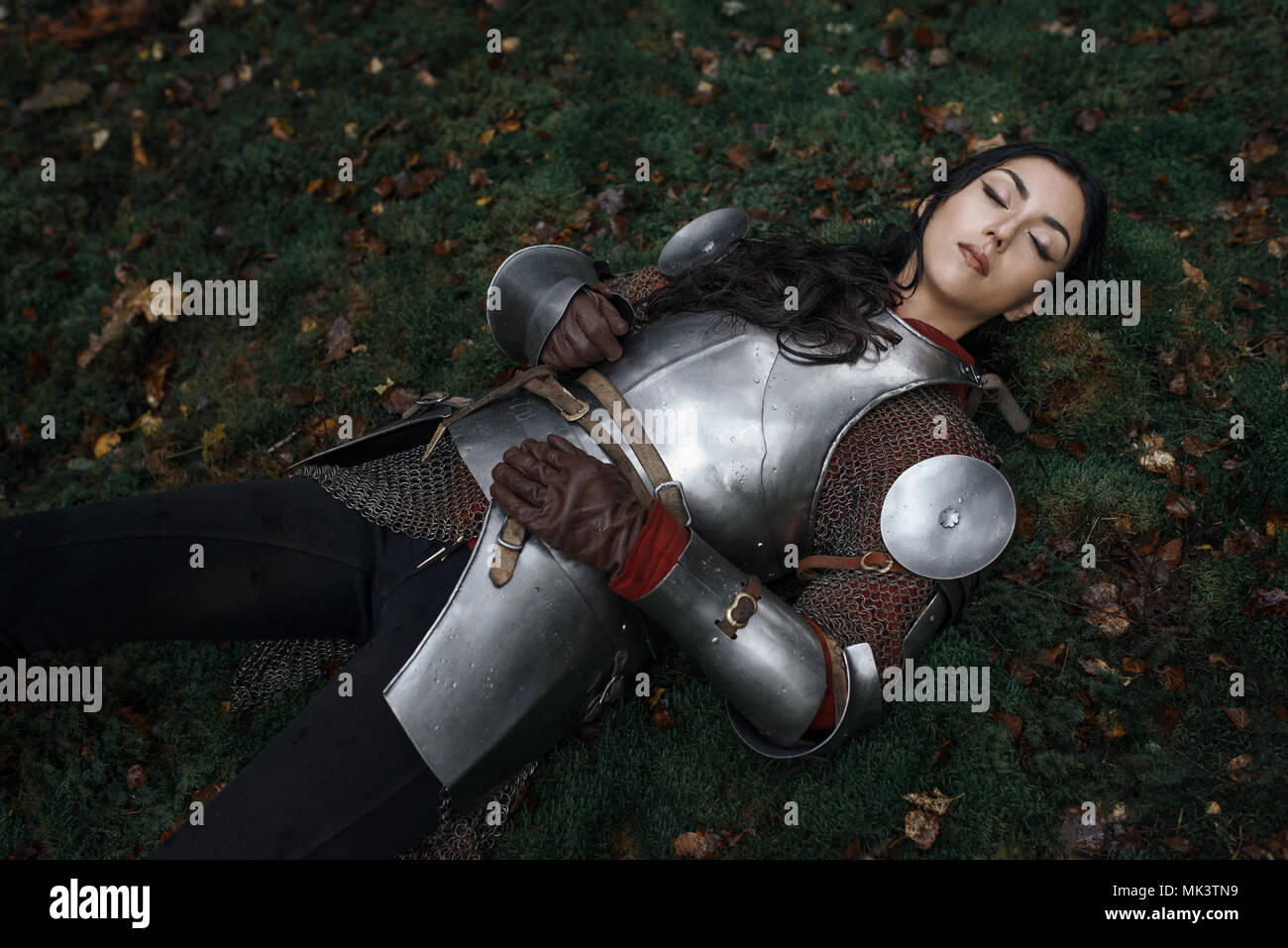 A Beautiful Warrior Girl Wearing Chainmail And Armor Lying On The