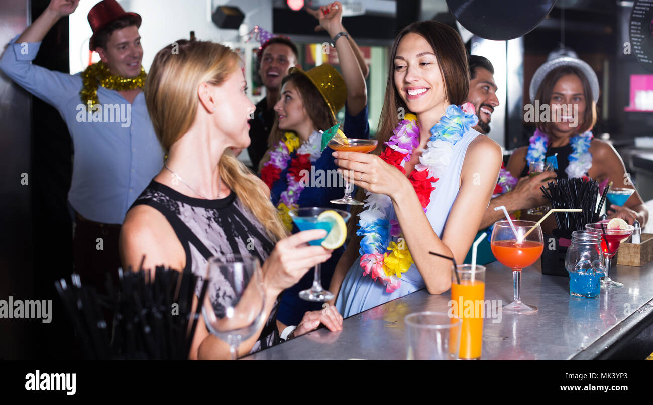 Young women are drinking cocktails on hawaiian party in nightclub Stock ...