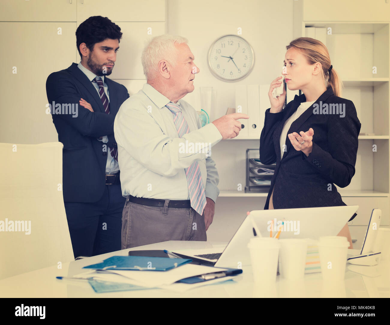 Mature boss is chastising employees because of uncompleted work in the office Stock Photo - Alamy