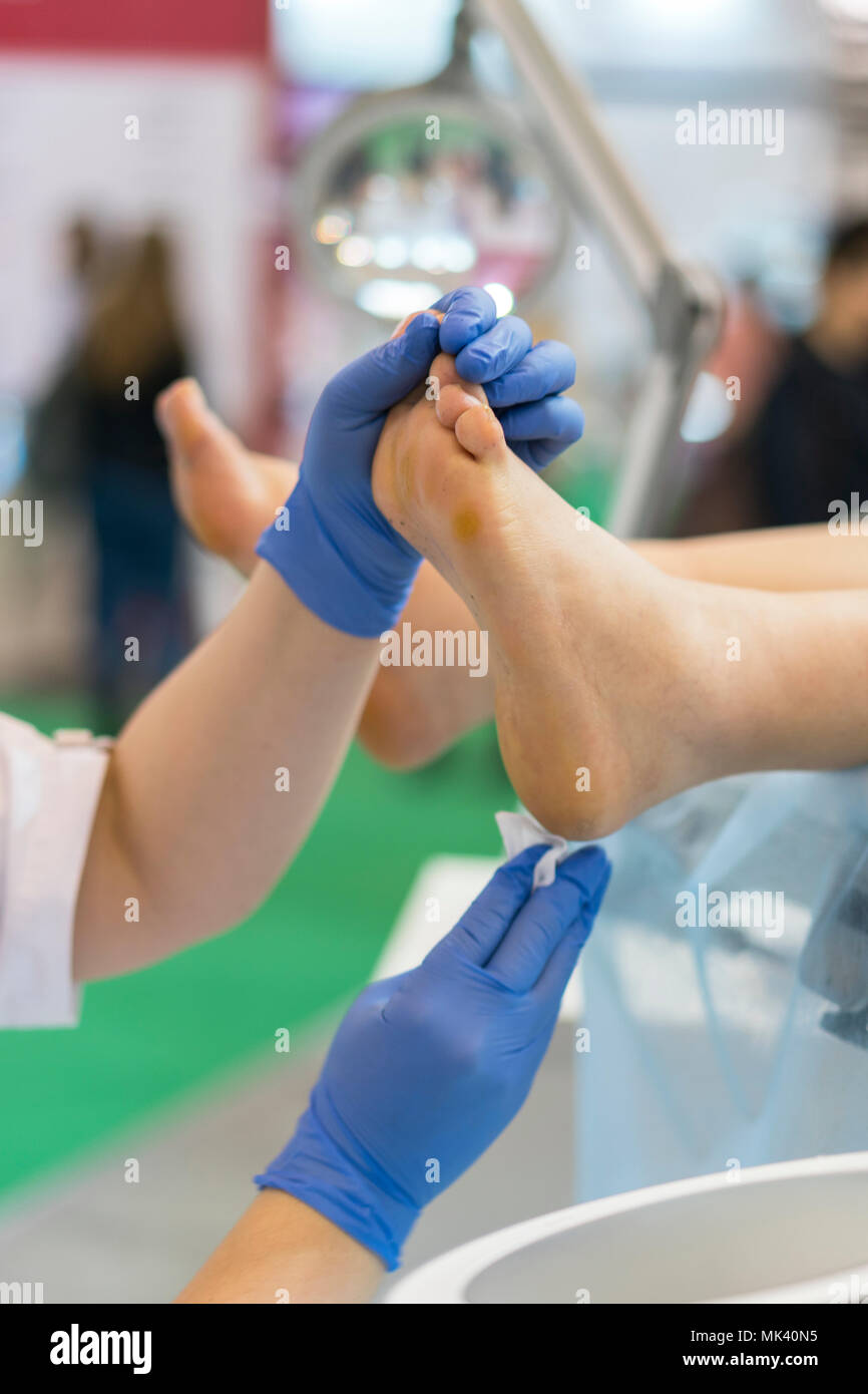 pretty doctor examining an elderly patient's foot Stock Photo - Alamy