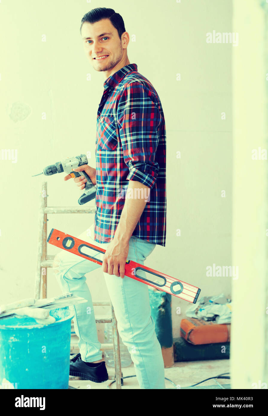 Portrait of young smiling man which is ready for his house renovation ...