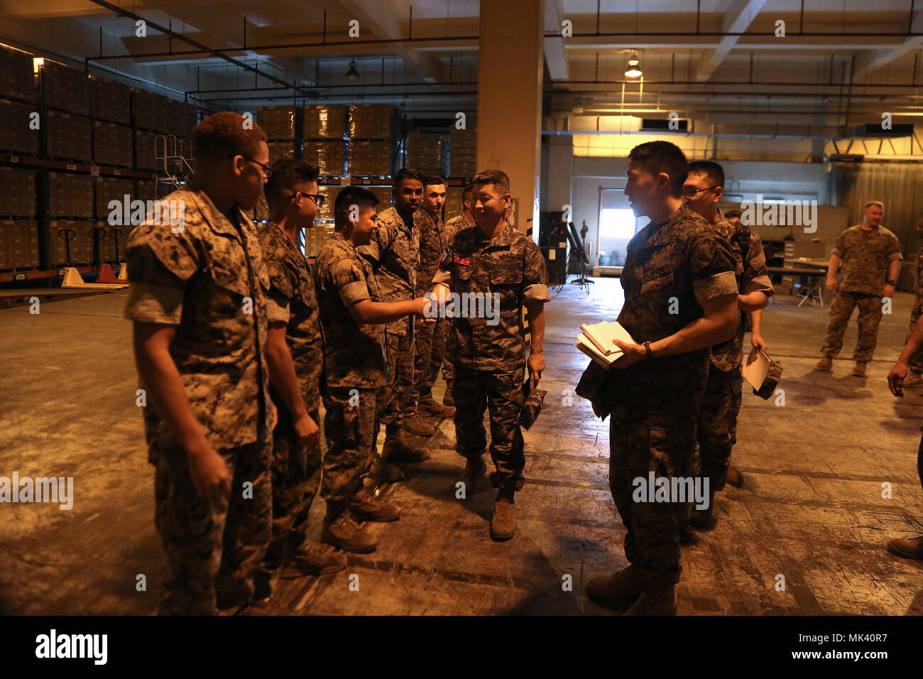 Republic of Korea (ROK) Marine Lt. Col. Min-ho Baek, center, meets and ...