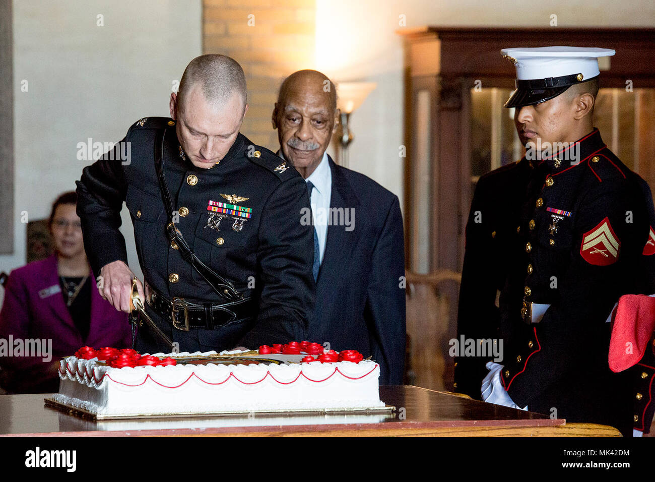 A Marine officer with the National Defense University cuts the ...