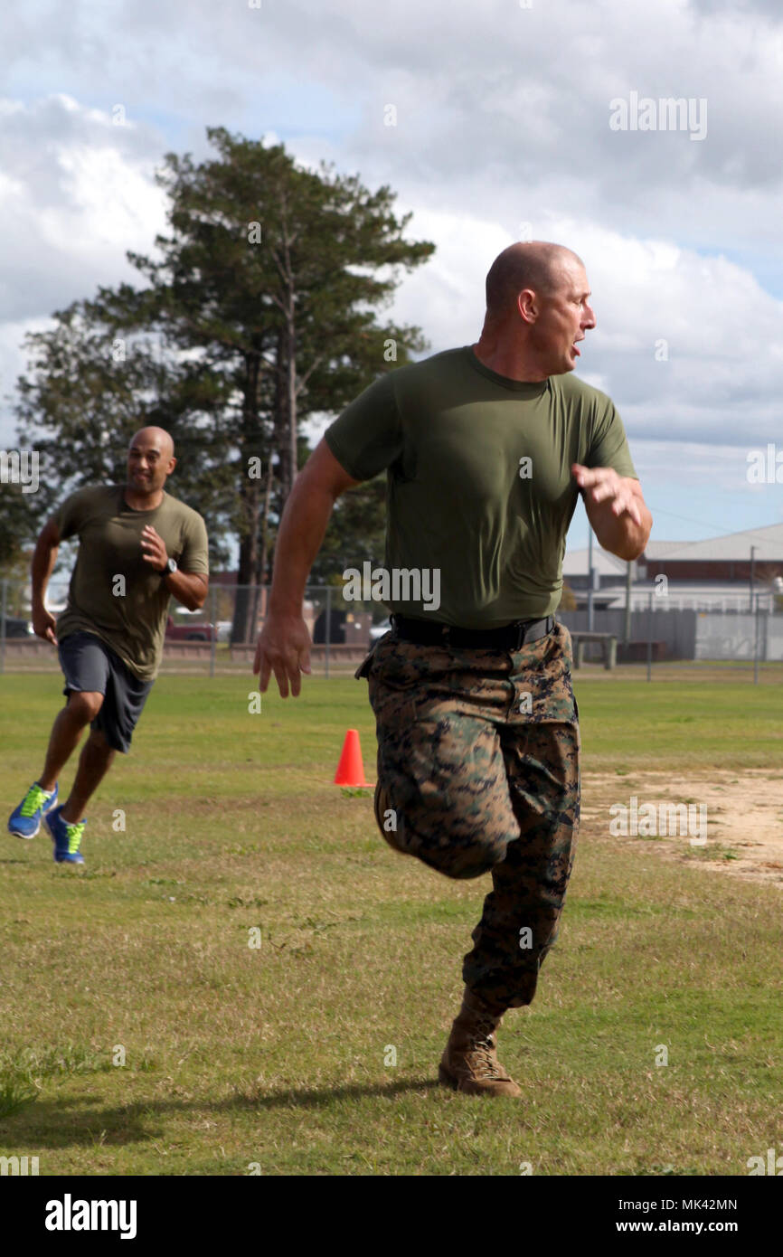 In a battle of titans, Sgt. Maj. Miguel Betancourt, left, races Sgt ...