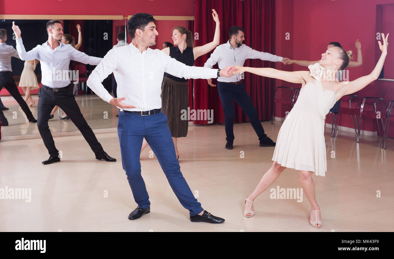 Young positive people dancing rock-and-roll in pairs Stock Photo - Alamy