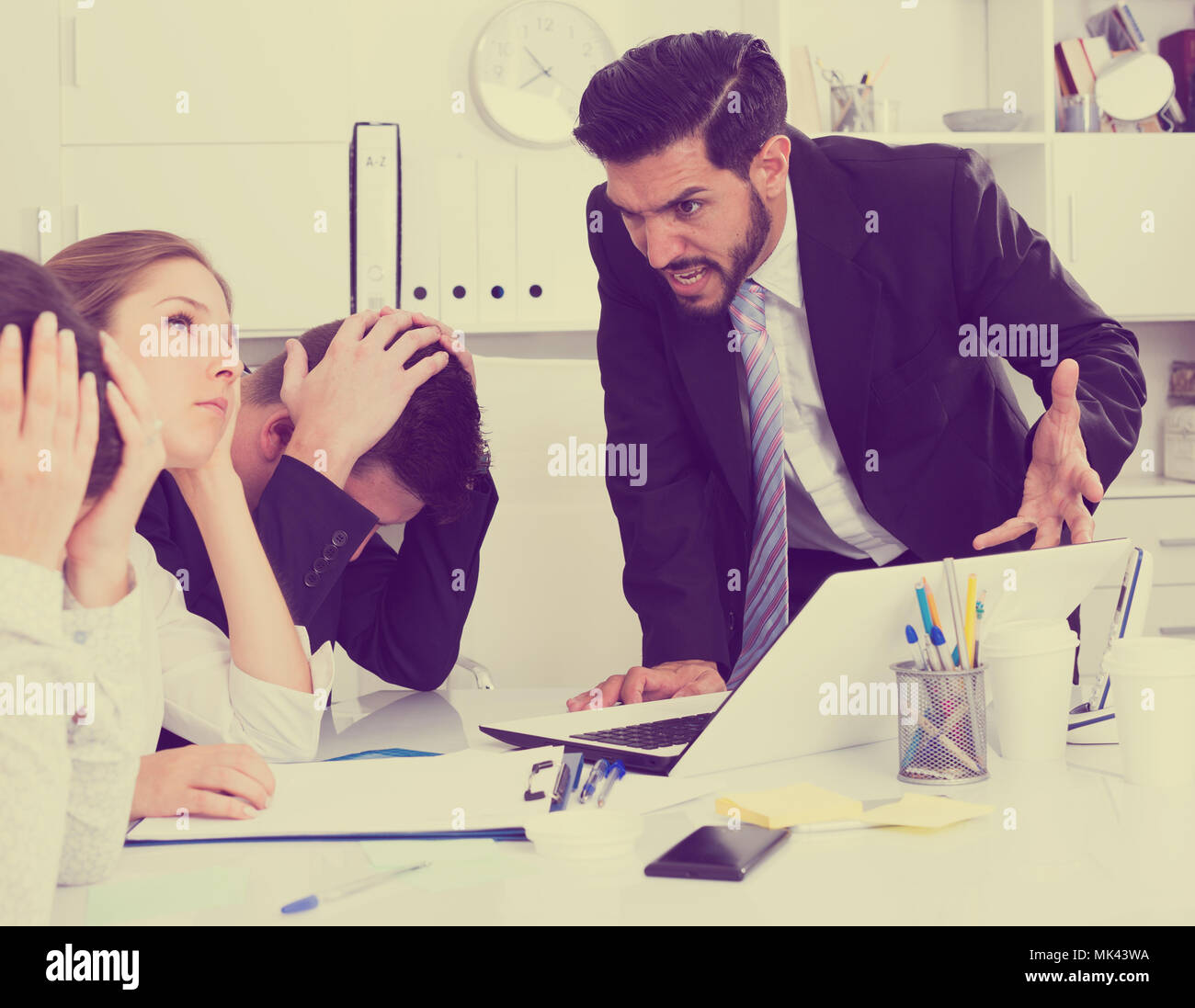 Businessman feeling angry to coworkers in office, pointing out mistakes ...