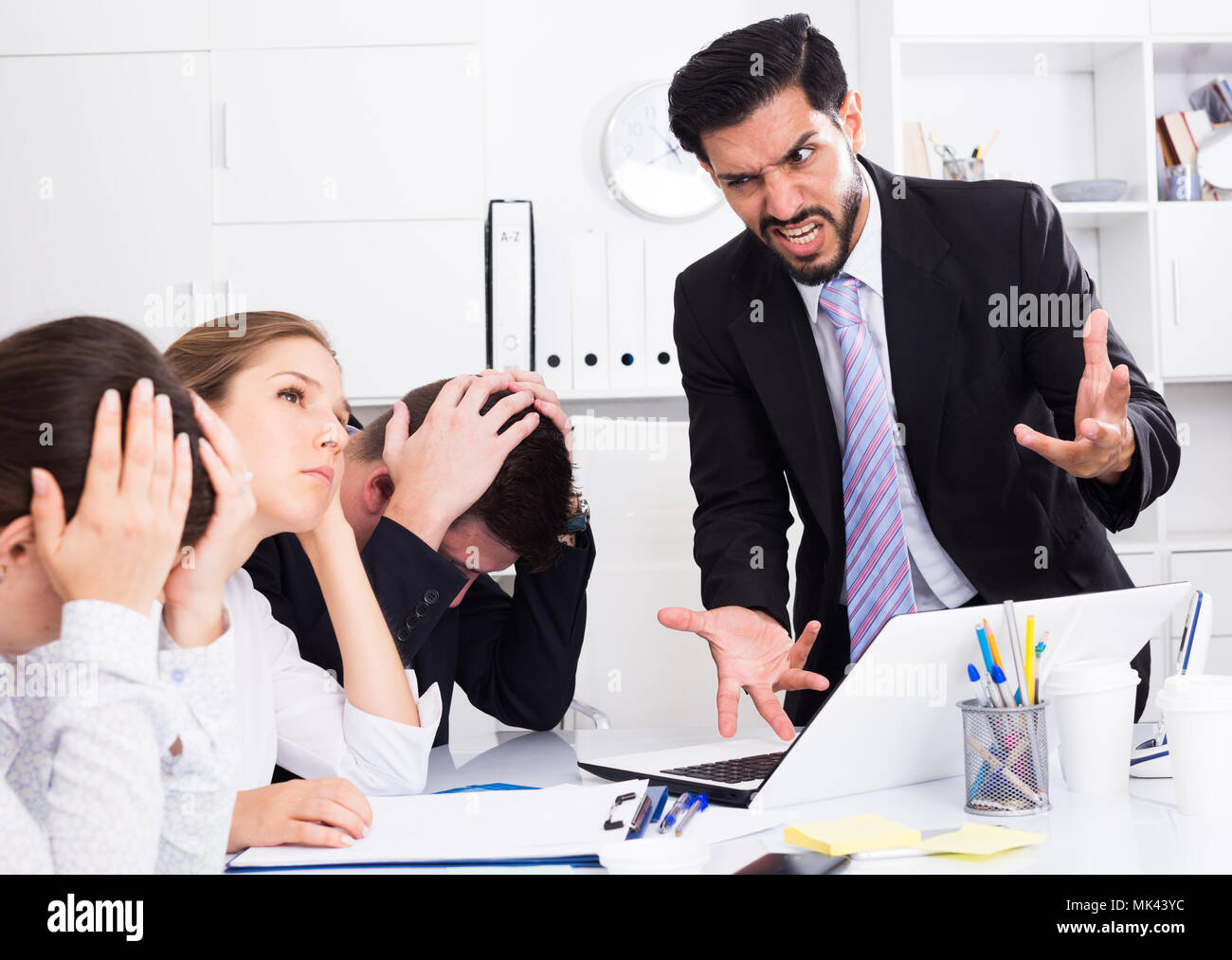 Outraged manager expressing dissatisfaction with teamwork of colleagues ...