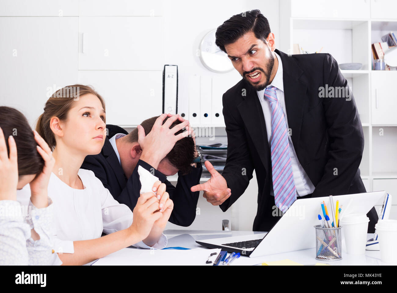 Businessman feeling angry to coworkers in office, pointing out mistakes ...