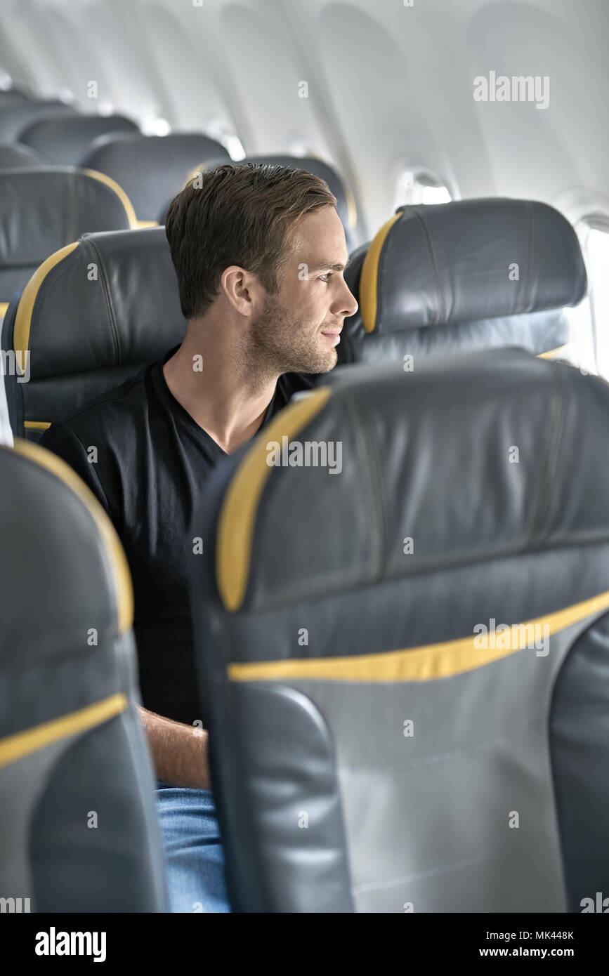 Handsome guy in airplane Stock Photo - Alamy