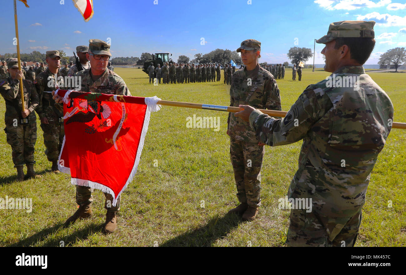 Command Sgt. Maj. James Kendrick unfurls the new colors for the 753rd ...
