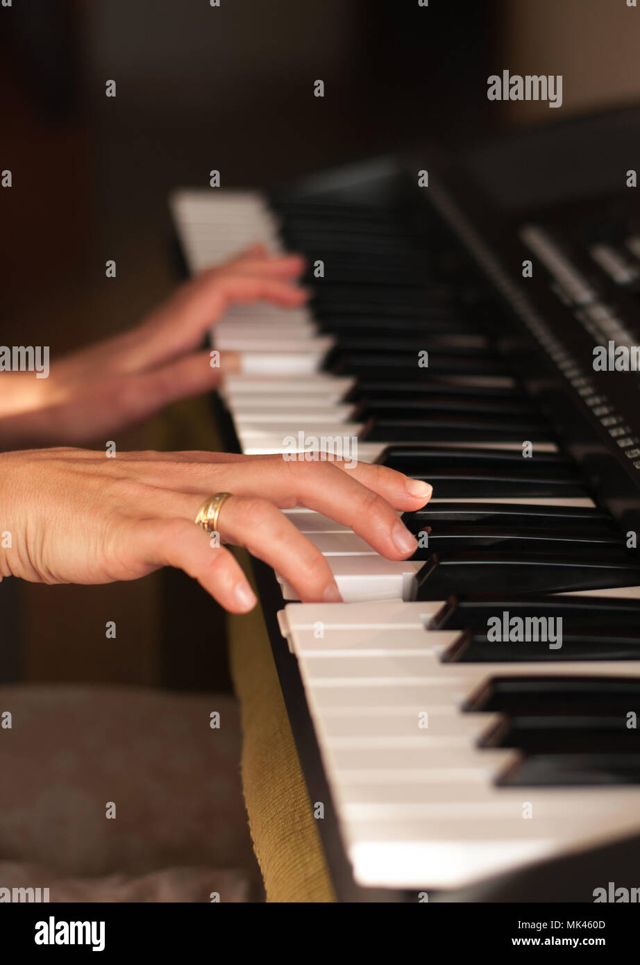 hands of the girl playing the piano close-up Stock Photo - Alamy