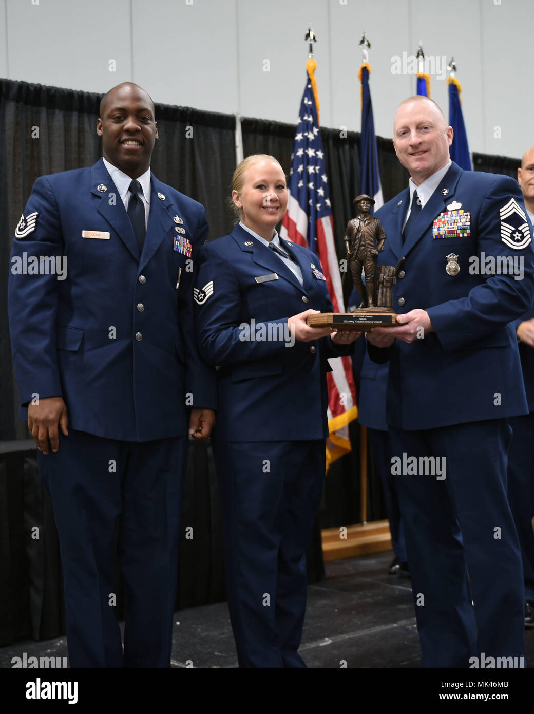 Chief Master Sgt. John Smith poses with Staff Sgt. Jaime Young and Tech ...