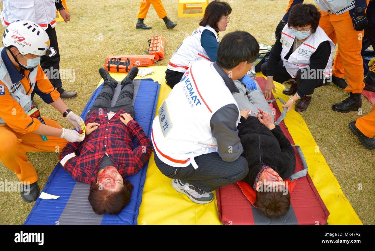 Korean emergency medical services personnel take care of the wounded during a bilateral, mass ...