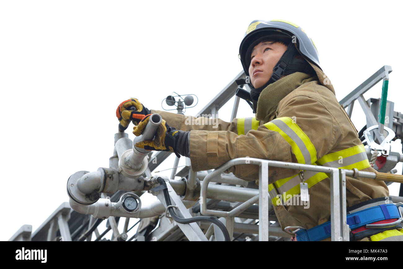A Korean firefighter readies a water cannon during a bilateral, mass ...