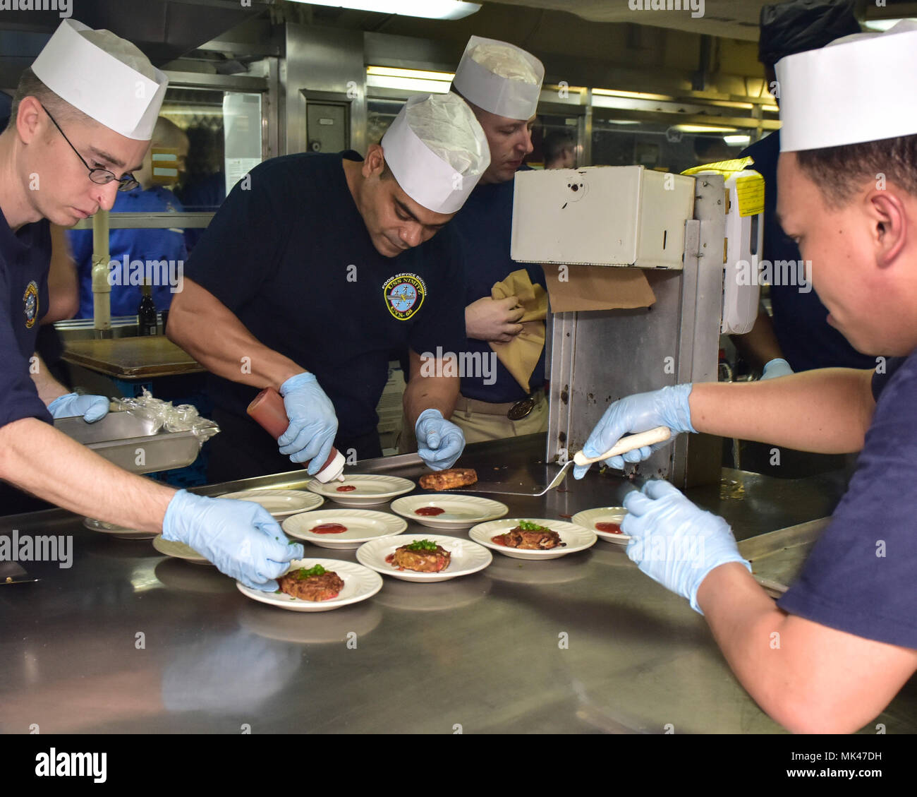 INDIAN OCEAN (Nov. 3, 2017) U.S. Navy Sailors prepare food for a Sailor ...