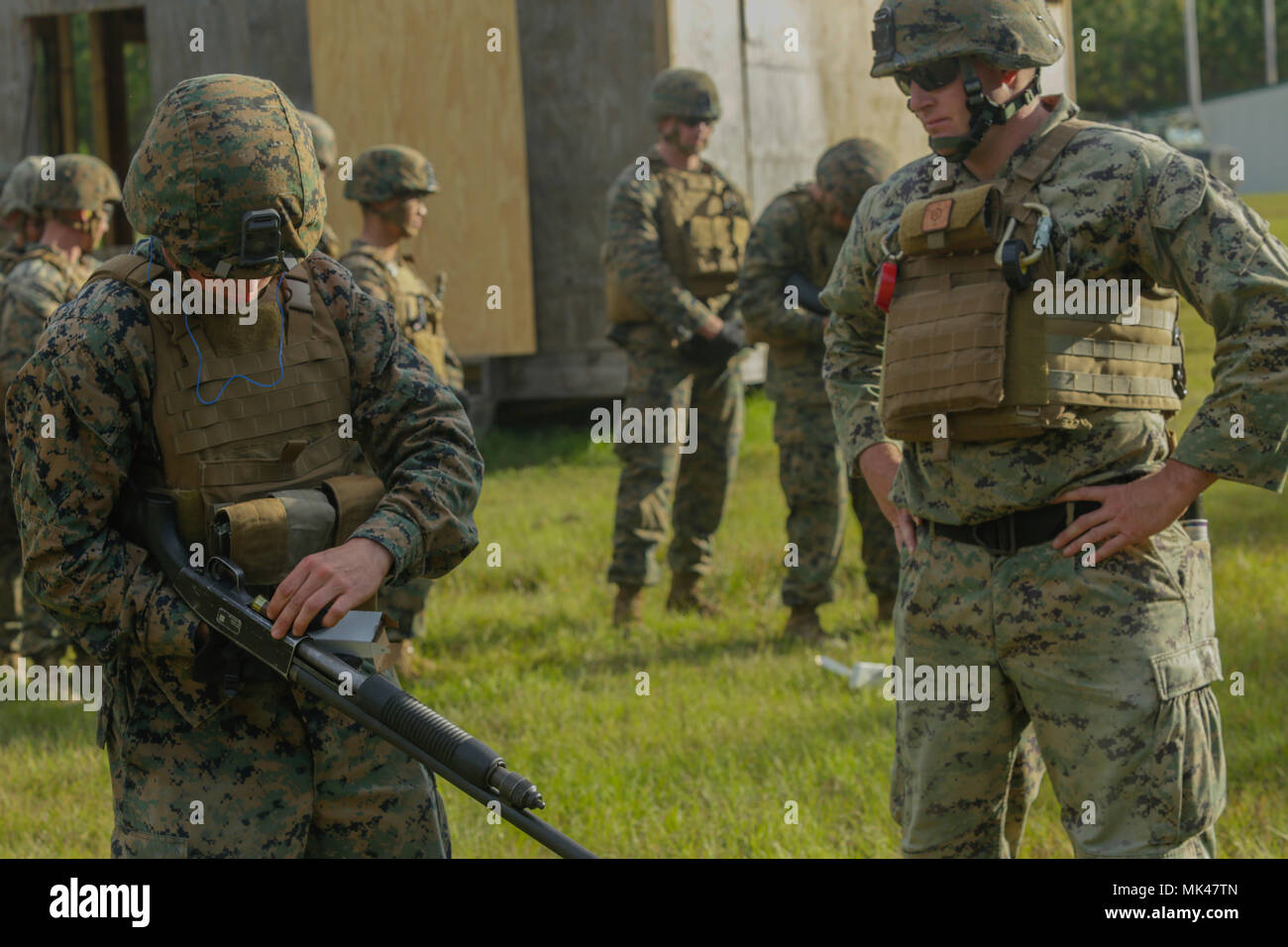 A Marine with 2nd Combat Engineer Battalion reloads a Mossberg 500 ...