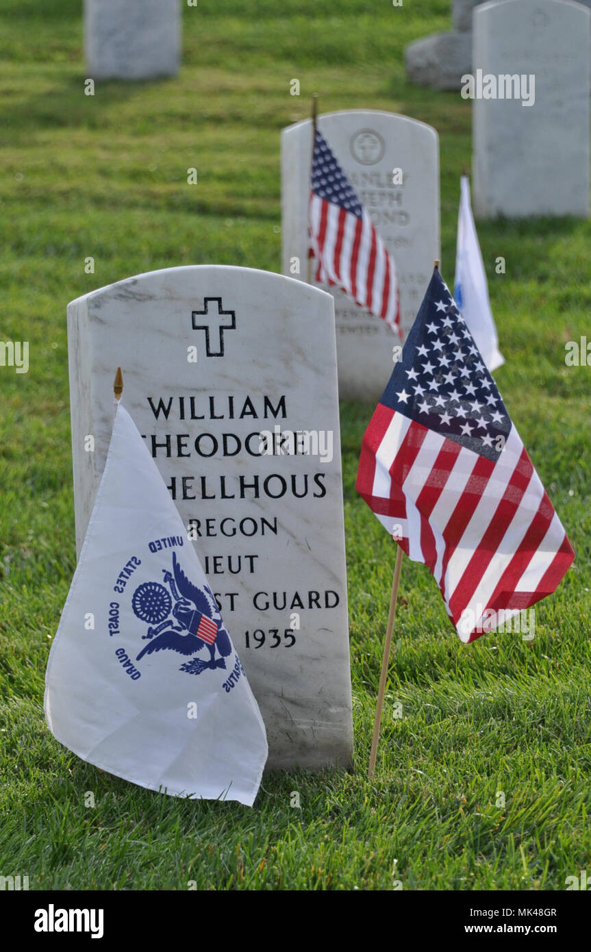 The United States and Coast Guard ensign are placed at the base of a ...