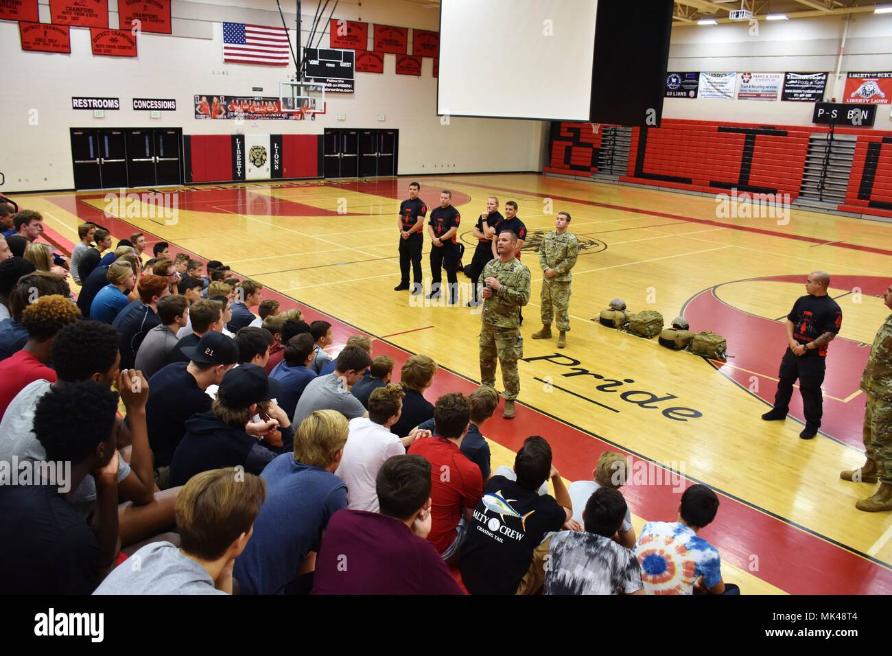 Sgt. 1st Class Aaron Figel (center), parachute demonstrator, talks to ...