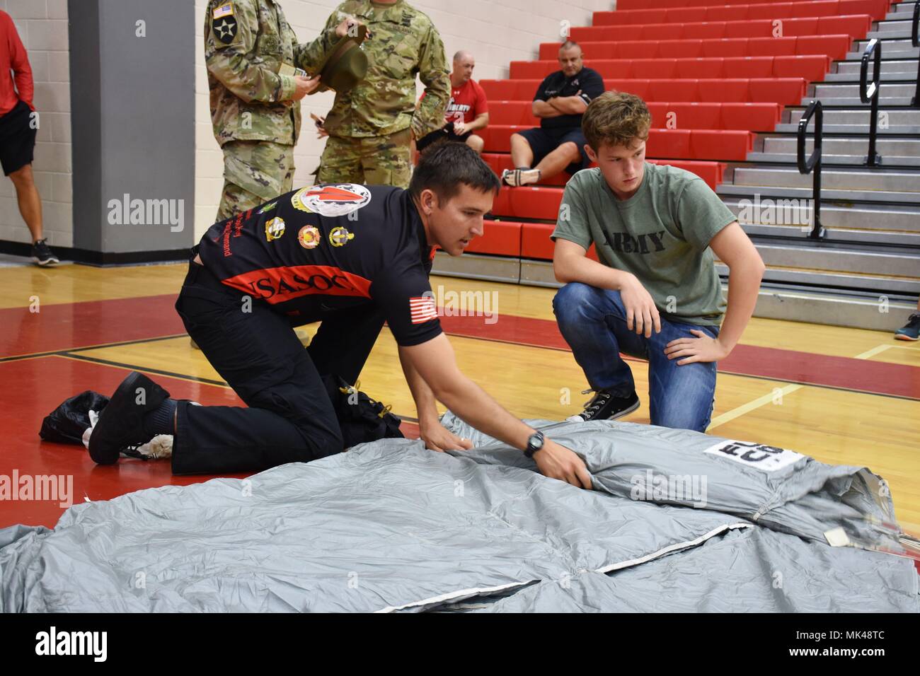 Staff Sgt. Sean O’ Toole (left), parachutist, shows a student from ...