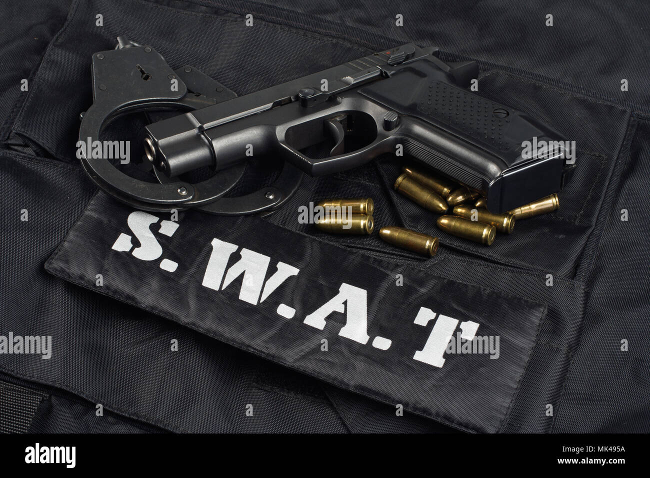 SWAT uniform with handgun and ammunition background Stock Photo - Alamy