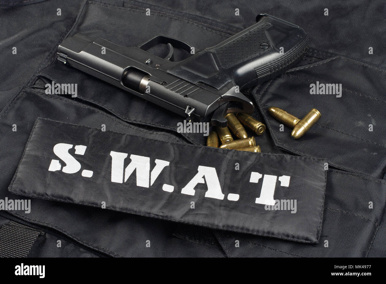 SWAT uniform with handgun and ammunition background Stock Photo - Alamy
