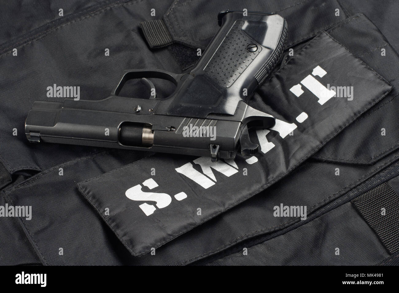 SWAT uniform with handgun and ammunition background Stock Photo - Alamy
