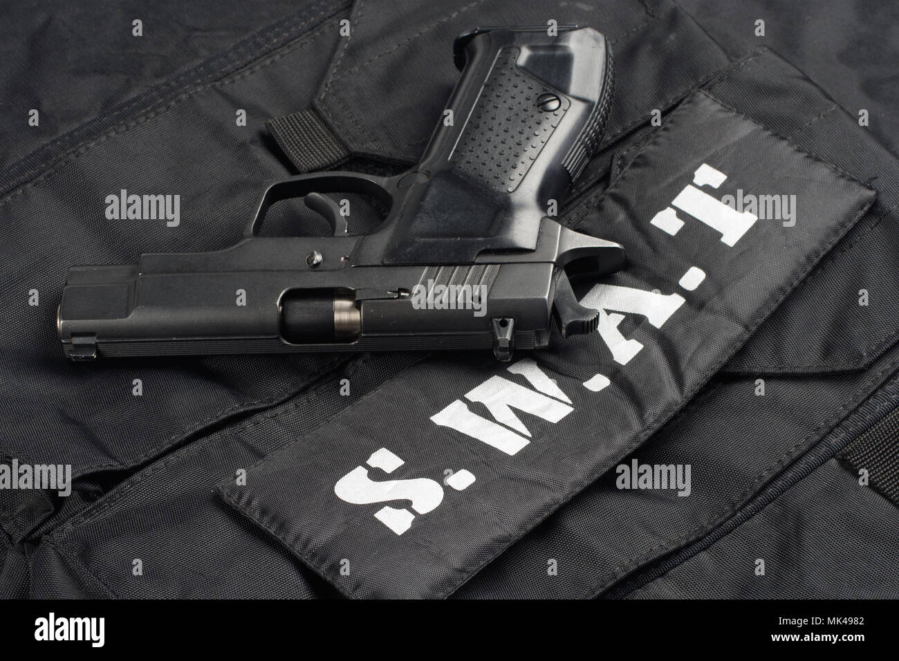 SWAT uniform with handgun and ammunition background Stock Photo - Alamy