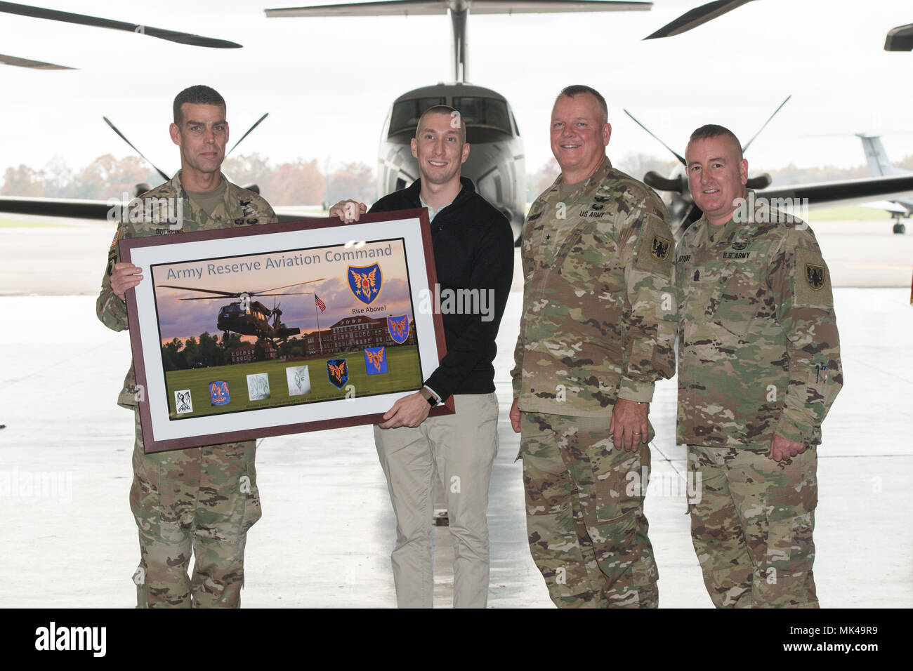 SGT Rafael Suarez is presented a plaque by COL Andrew Doehring, BG ...
