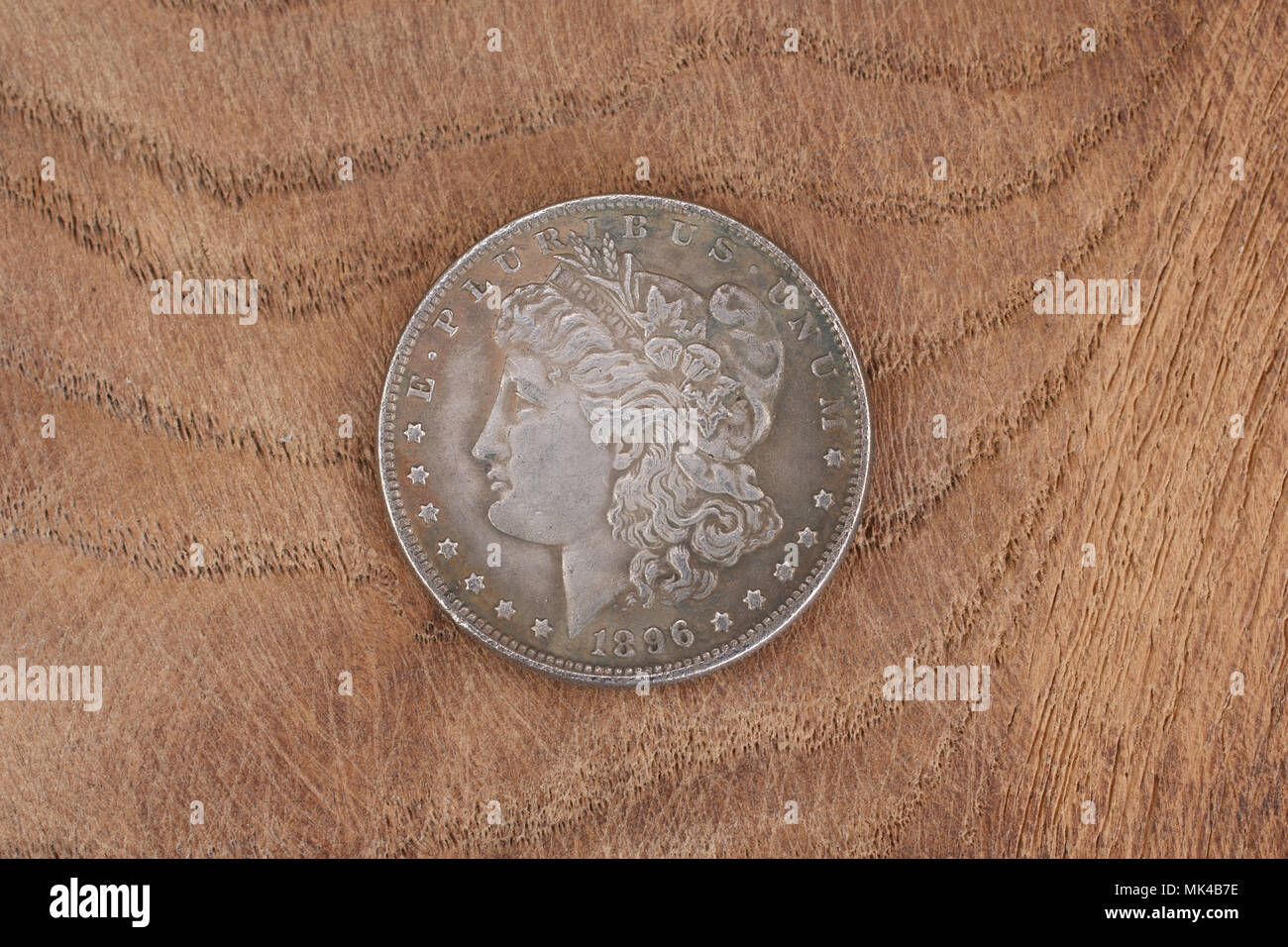 antique silver dollar on wooden background Stock Photo - Alamy