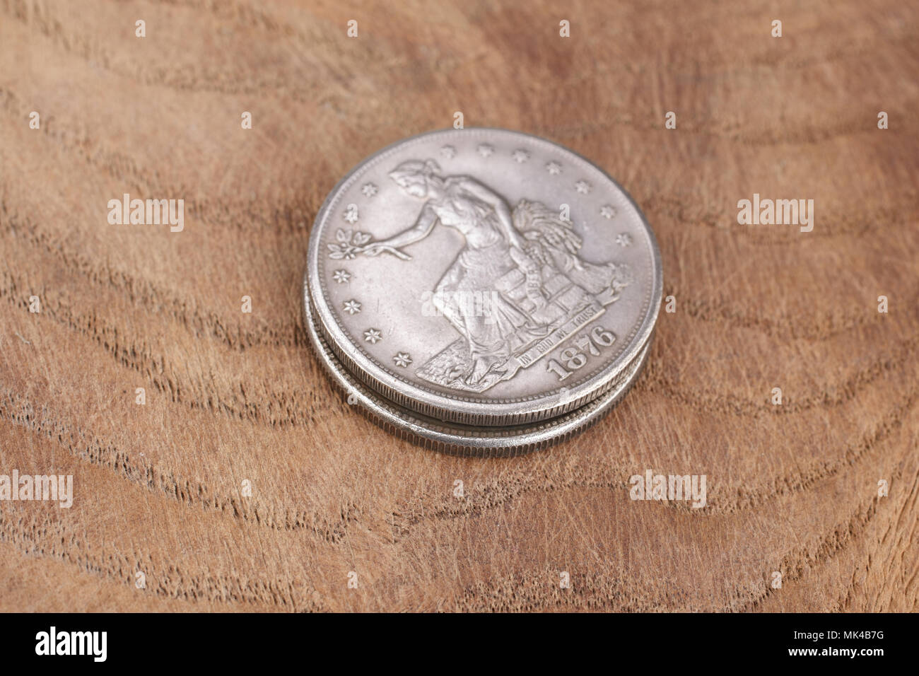 antique silver dollar on wooden background Stock Photo - Alamy