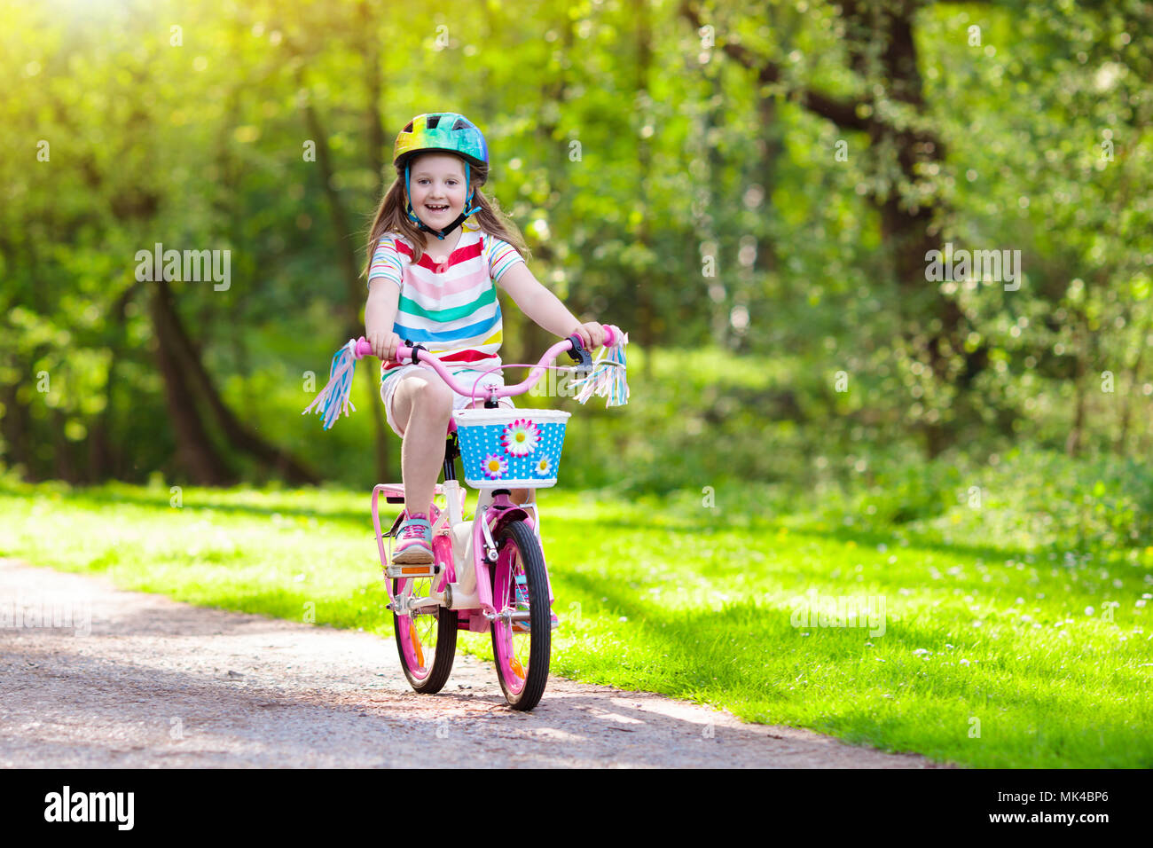Child riding a bike in summer park. Little girl learning to ride a bicycle without training wheels. Kindergarten kid on two wheeler bike. Active outdo Stock Photo Alamy