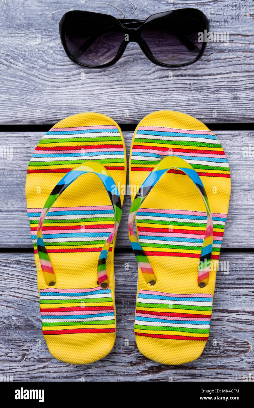 Yellow flip flops and sunglasses. Pair of sandals and spectacles Stock ...
