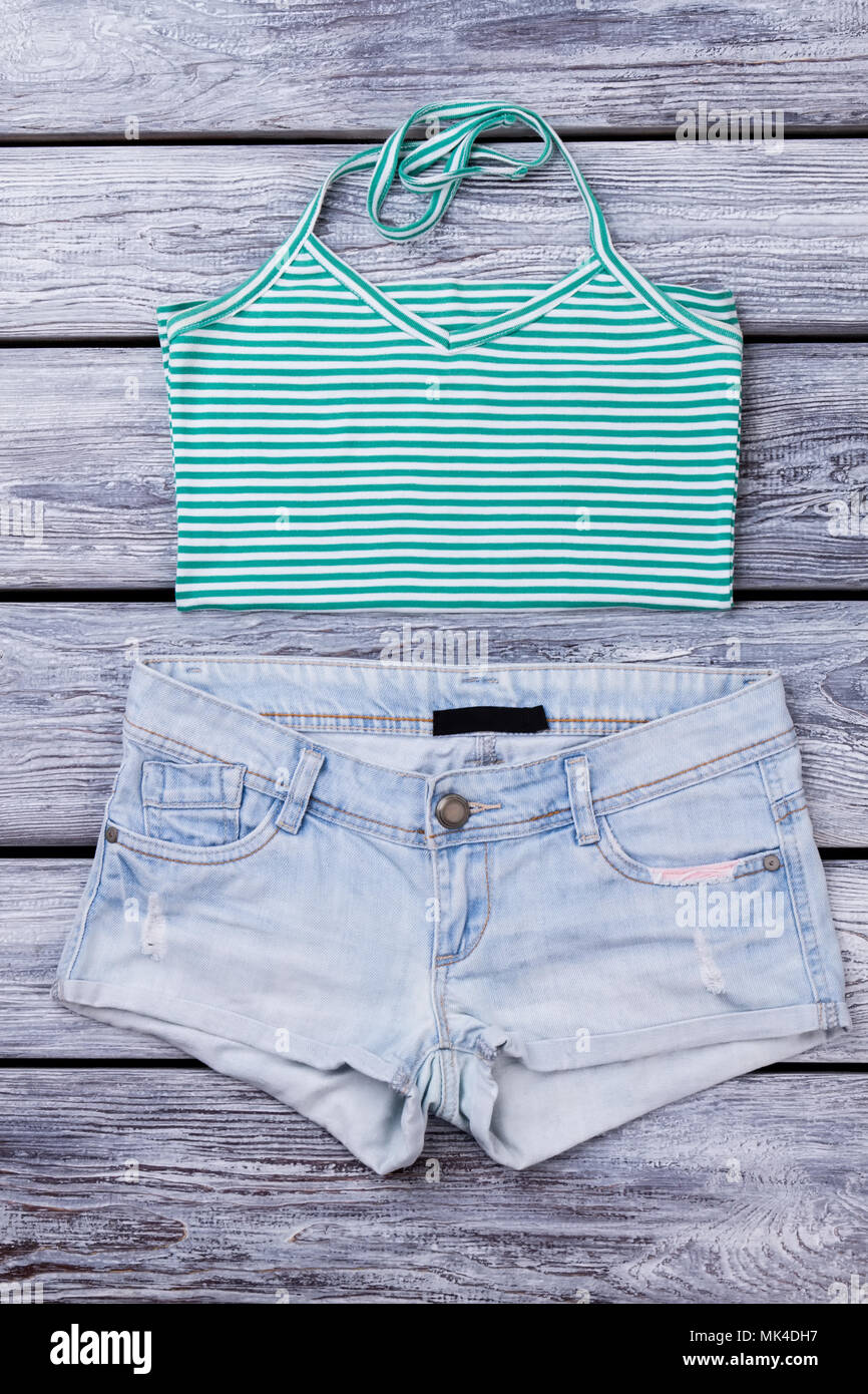Denim female jeans and blouse. Flat lay, top view. Wood desk surface ...