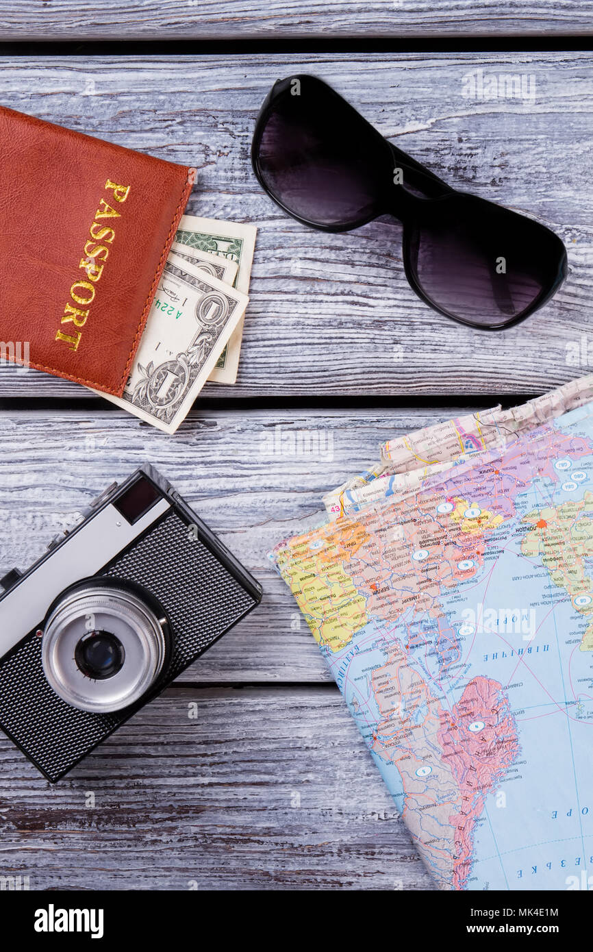 Travel objects flatlay. Vintage photo camera, passport, money ...