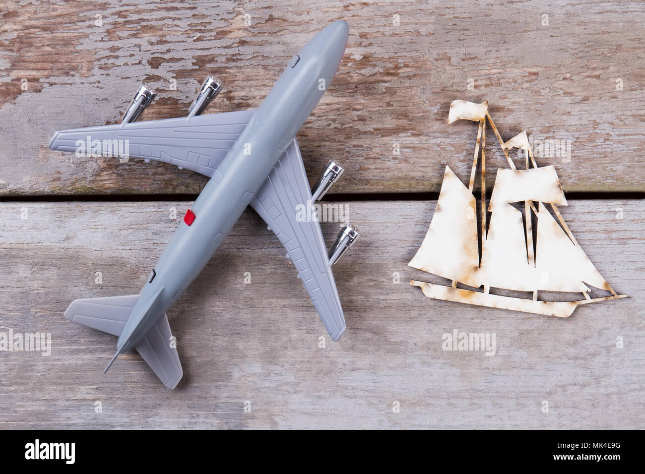 Toy plastic plane and flat wooden ship. Flat lay, top view. Wooden ...