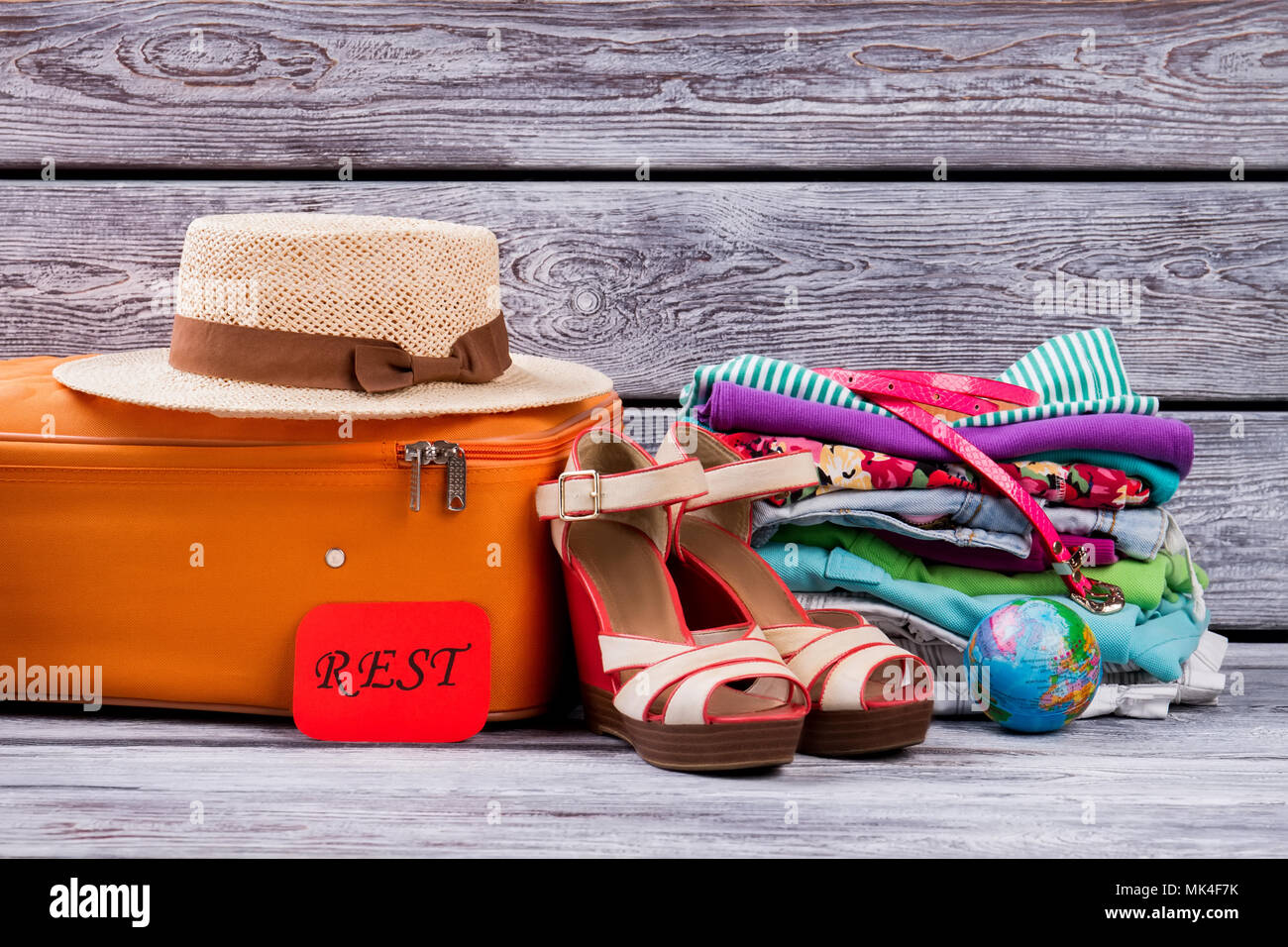 Light summer clothes for vacation. Grey wooden surface background Stock ...
