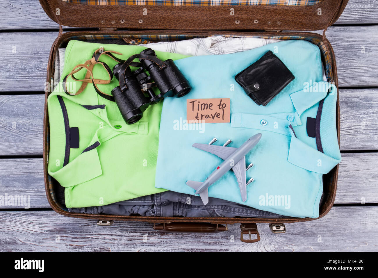 Opened suitcase packed with clothes. Top view, flat lay. Travel ...