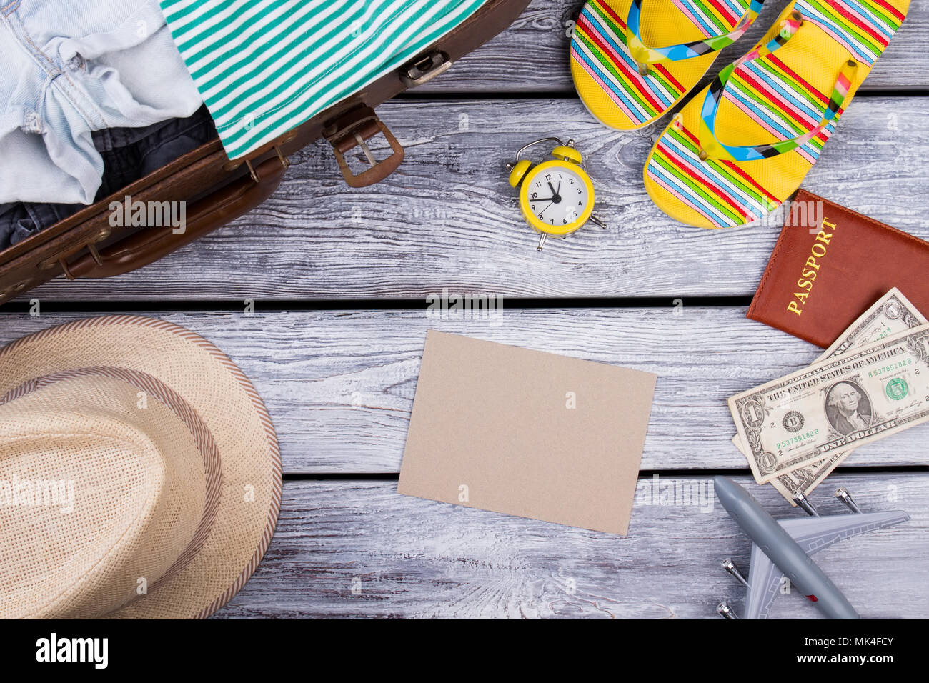 Travel items arrangement with plank paper with copyspace. Wooden desk ...