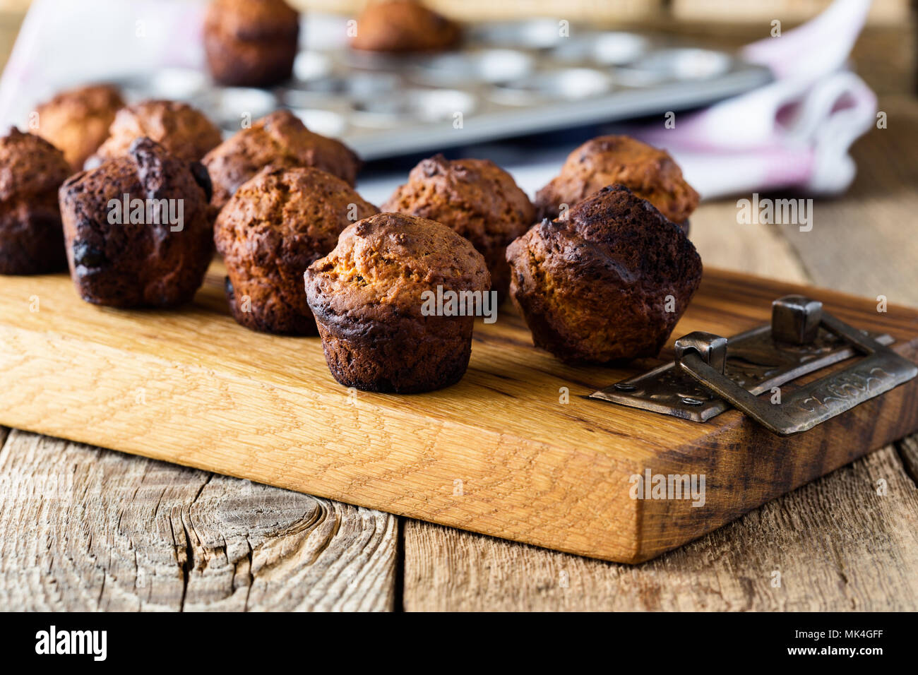 Burnt muffins on rustic wooden table, messy kitchen situation in the ...
